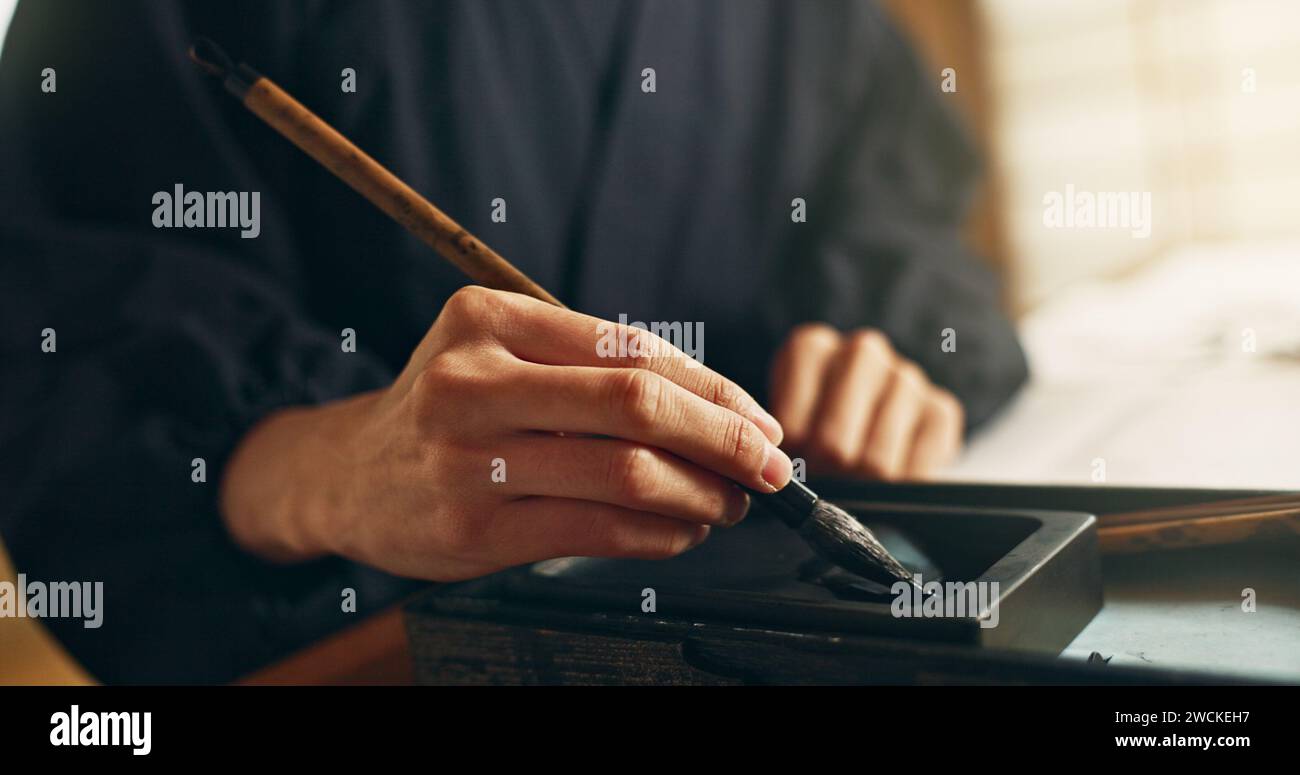 Hands, reed pen or brush in ink for writing, calligraphy or ancient ...