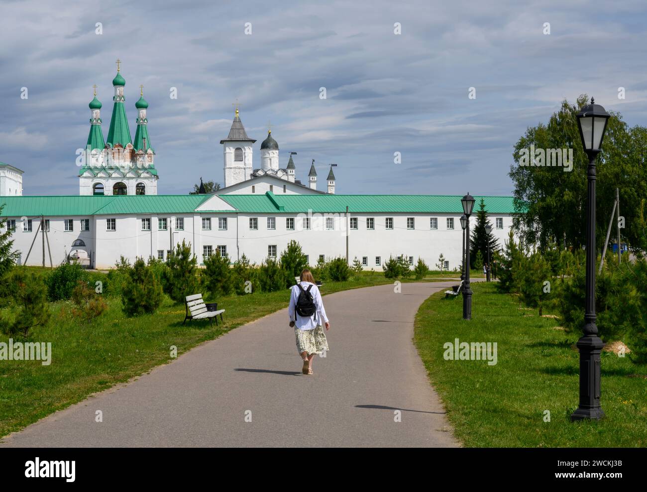 A girl walks along the road to medieval cathedrals and churches of the ...