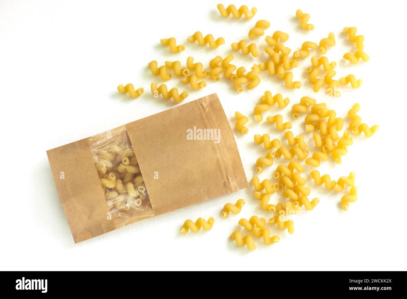 Kraft paper pouch bag with pasta and wheat spikelets on a white ...