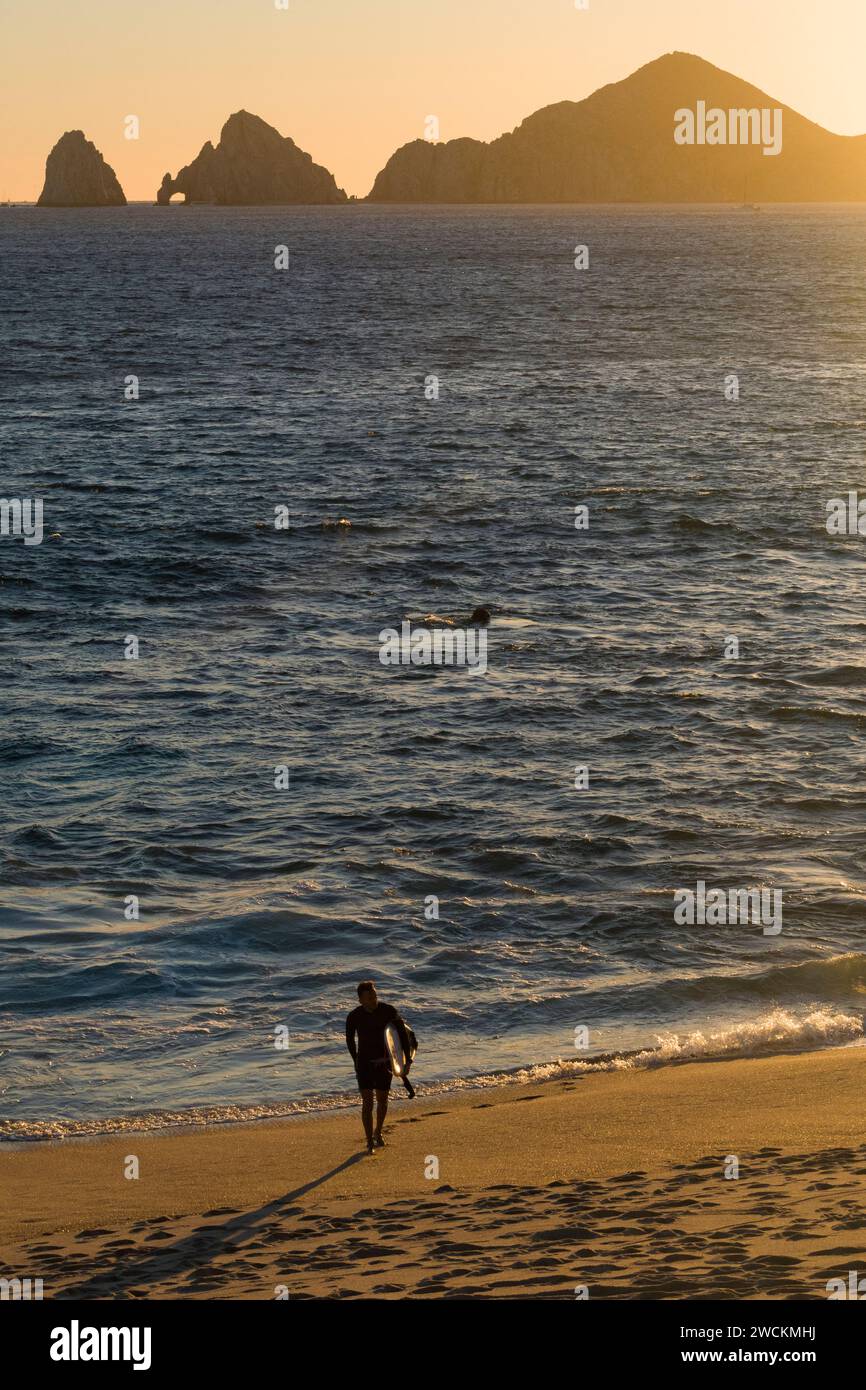 Surfing across from El Arco at sunset, Cabo San Lucas, Baja California ...