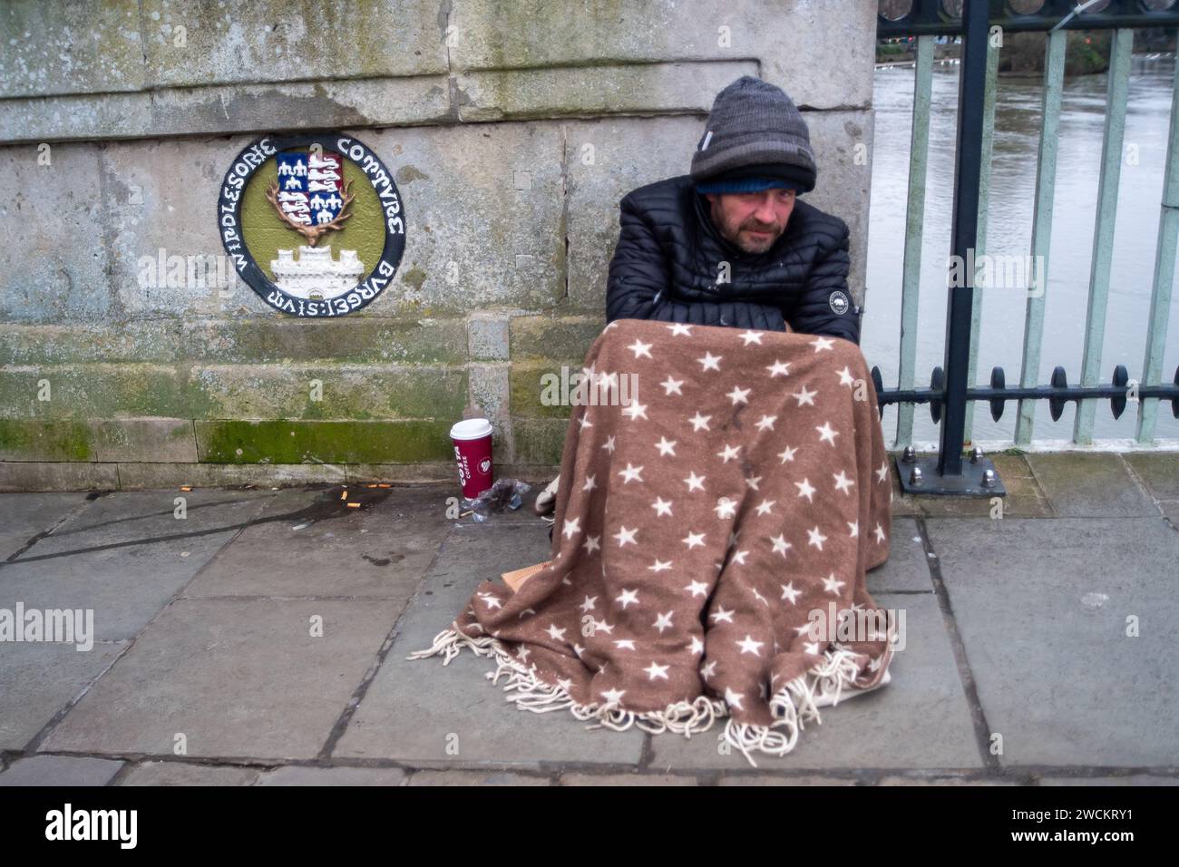 Eton, Windsor, UK. 16th January, 2024. A homeless man sadly sits on ...