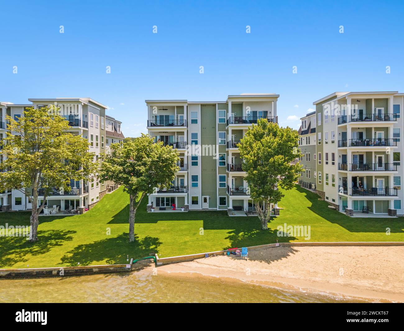 Two waterfront apartment buildings near a sandy beach Stock Photo - Alamy