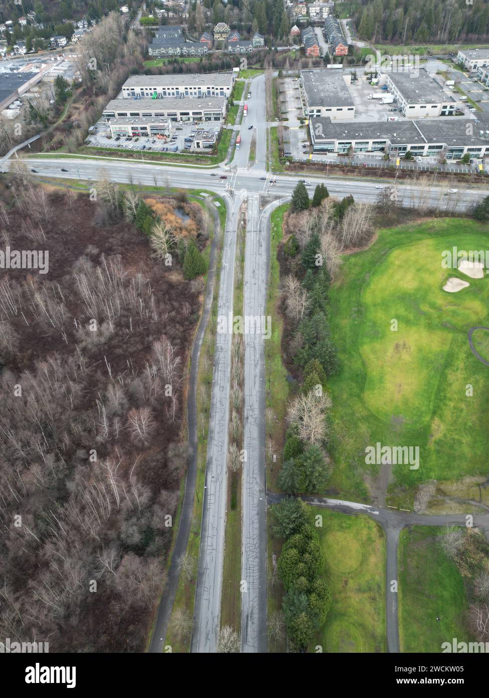 Aerial view of a vacant highway weaving through a bustling cityscape ...