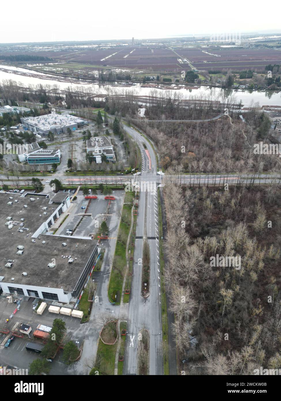 Aerial view of a vacant highway weaving through a bustling cityscape ...