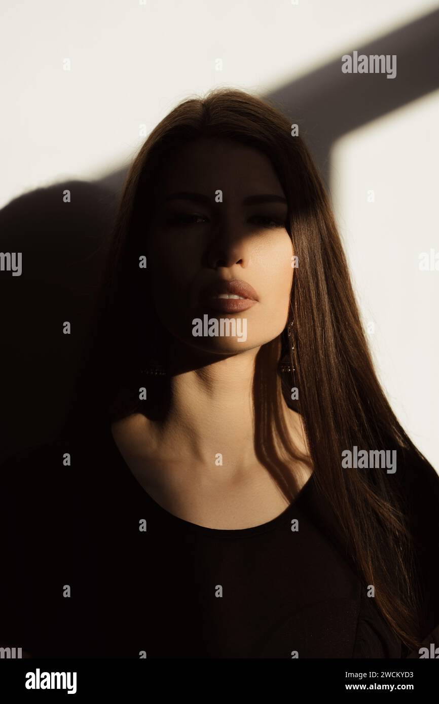 Woman With Long Hair Standing in Shadows Stock Photo - Alamy