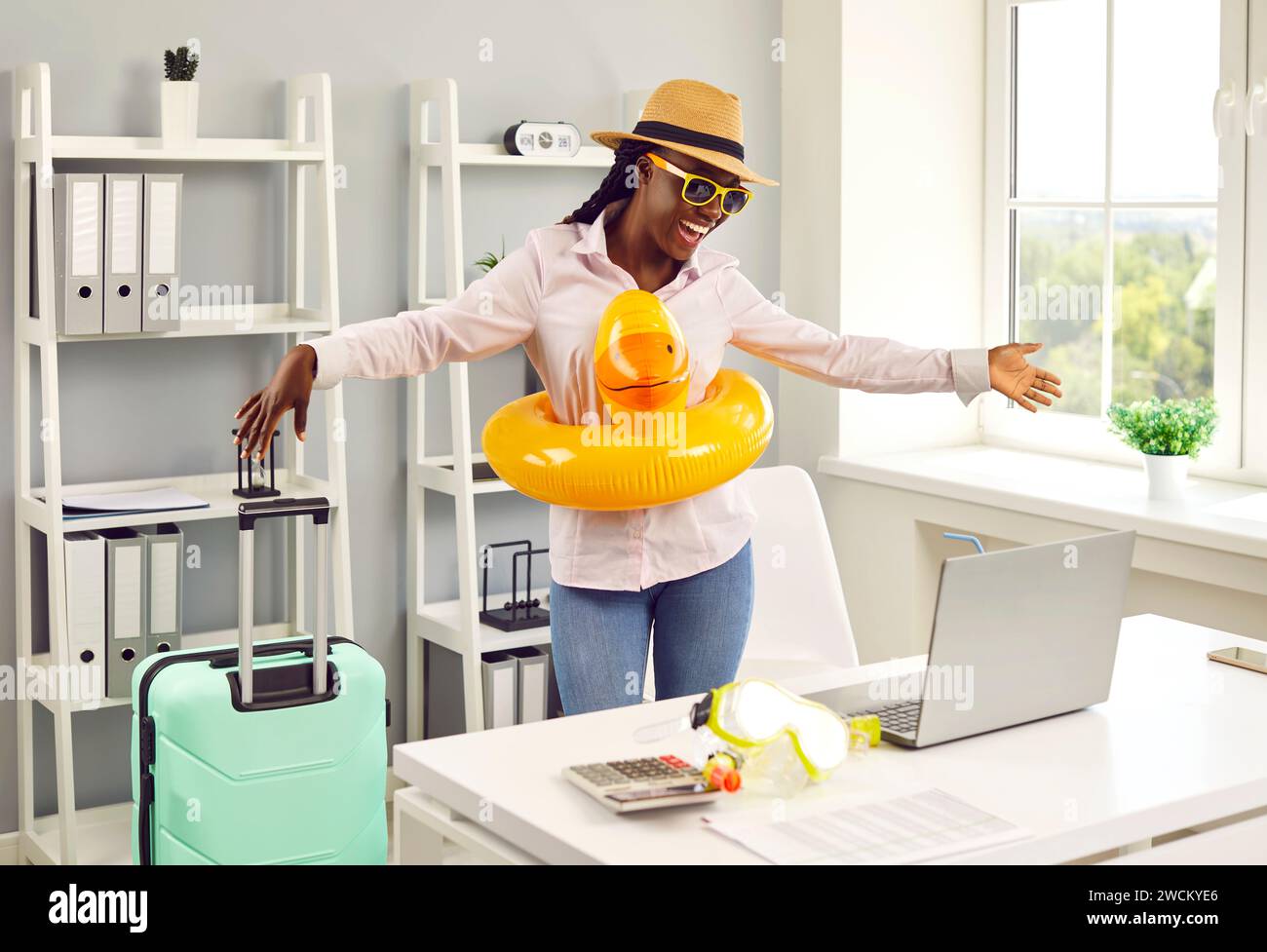 Funny woman standing at the desk on workplace at office and going for ...