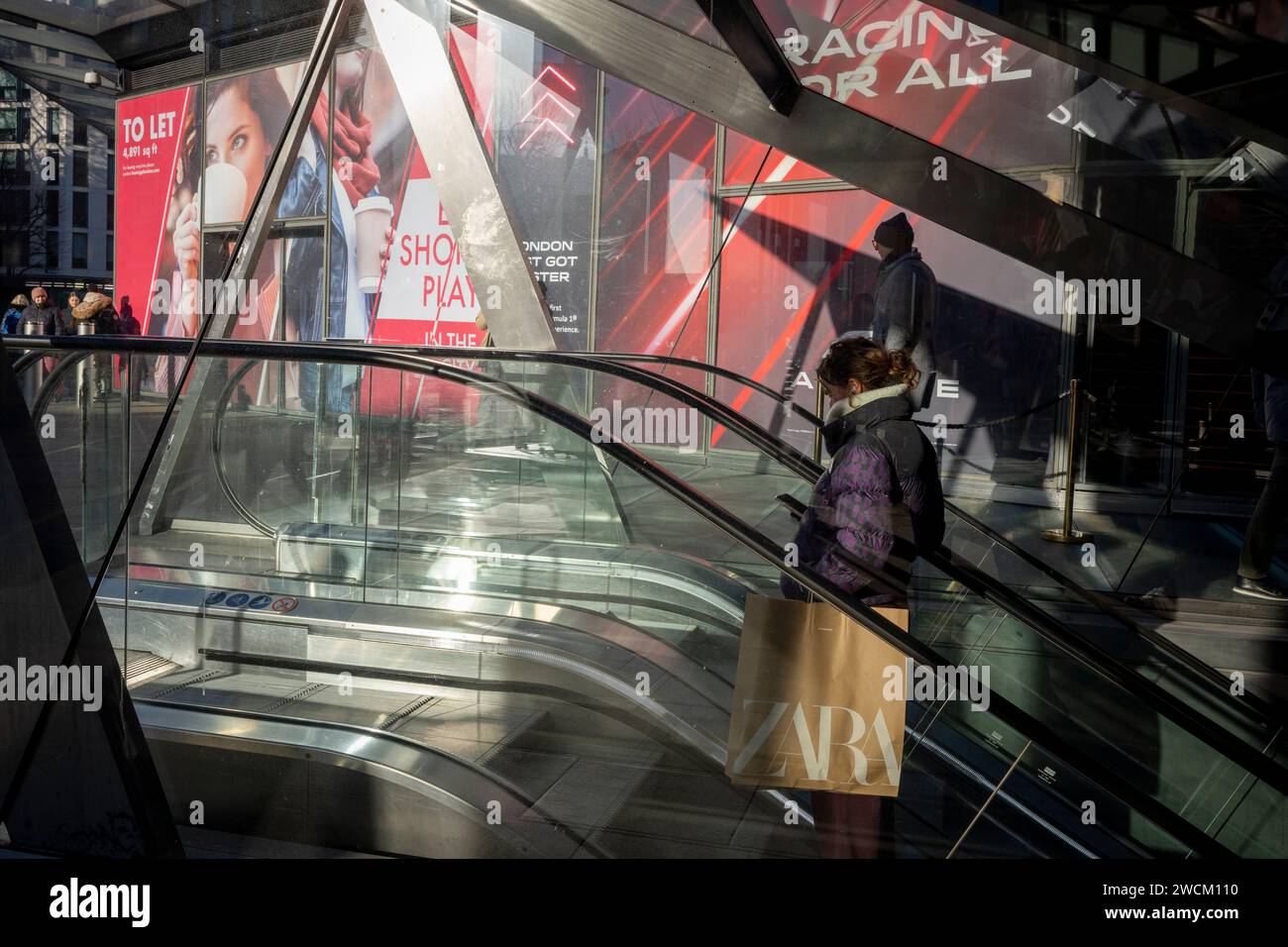 City workers and shoppers in an urban landscape of reflections and ...
