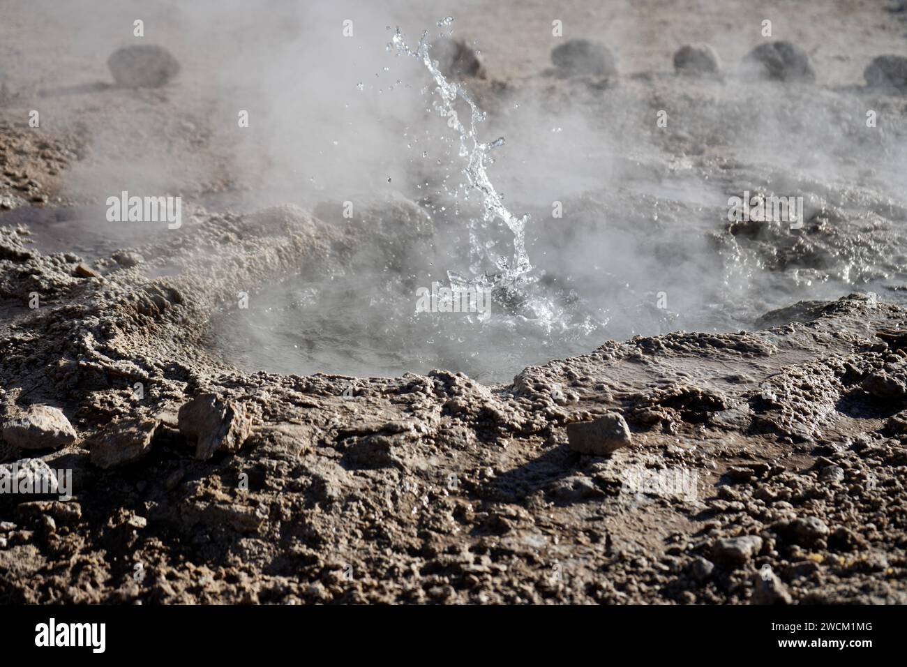 Hot water erupting from a geyser frozen in time. Geysers Del Tatio ...