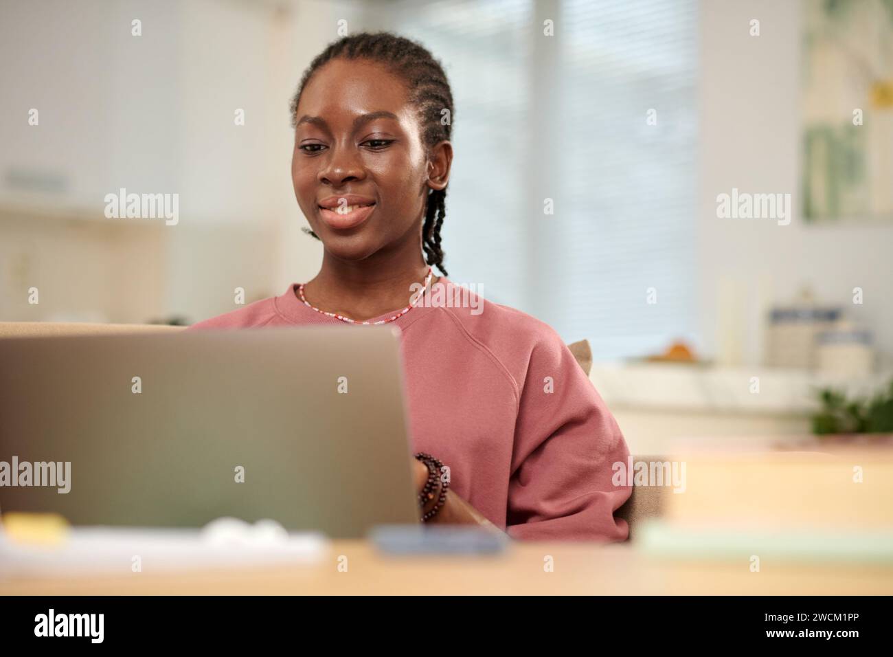 Portrait of smiling Black girl coding on laptop Stock Photo - Alamy