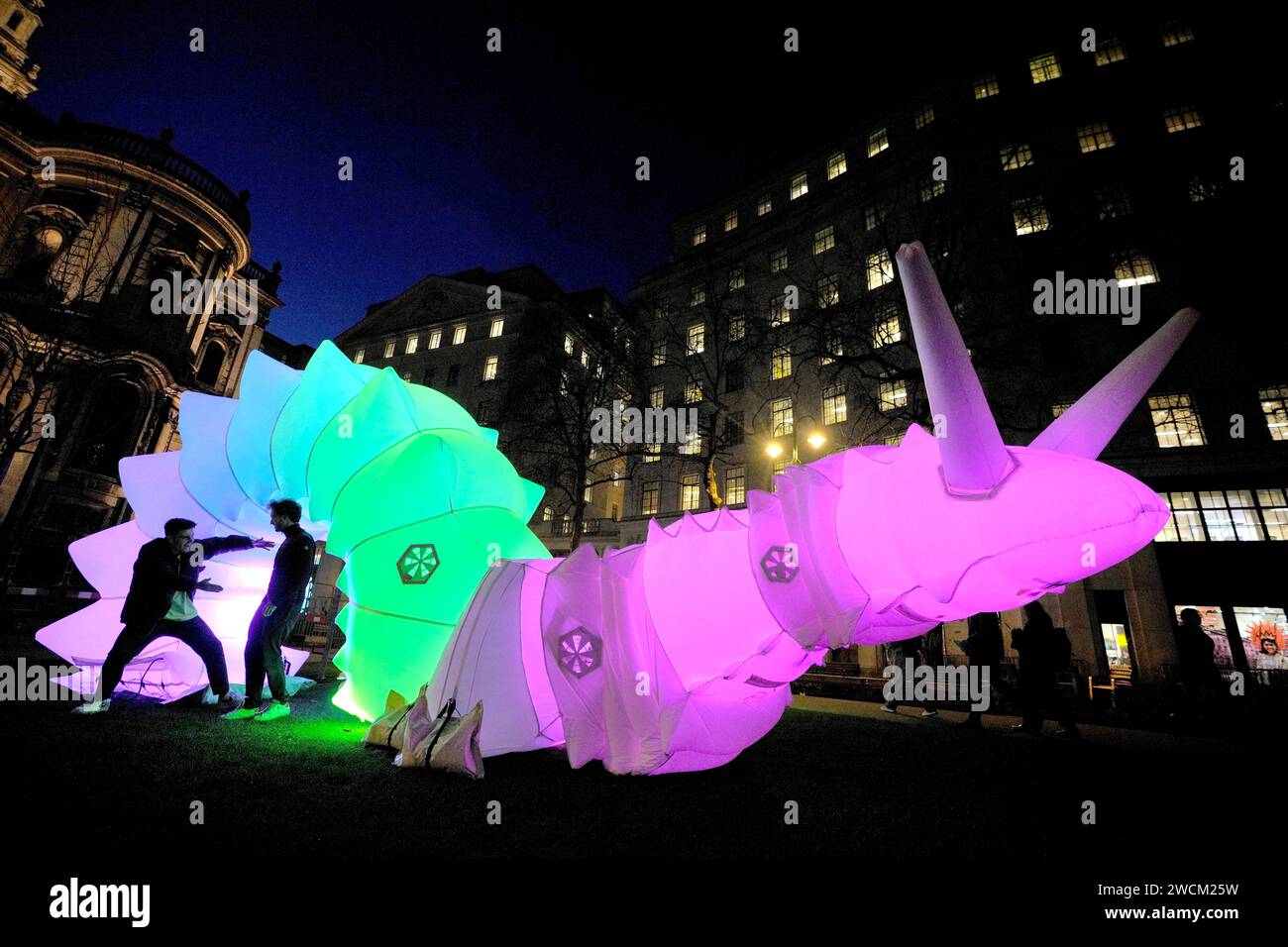 People interact with a giant inflatable robot as they are unveiled ...