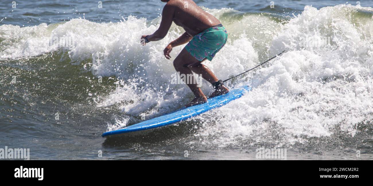 Witness the breathtaking moment as a daring surfer conquers a colossal ...