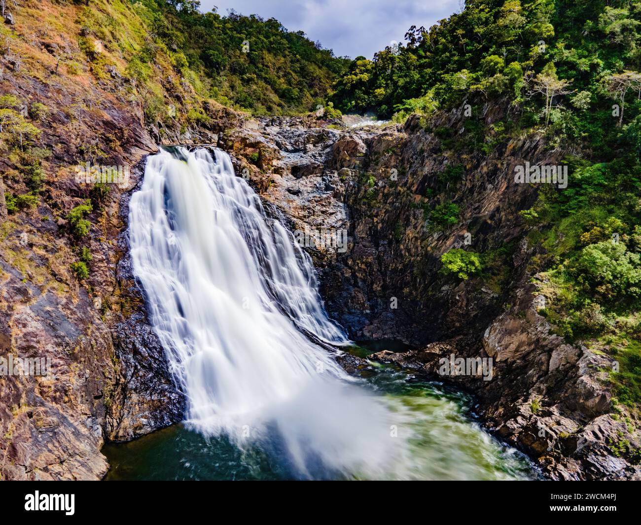 Cascading waterfall amidst verdant forest hi-res stock photography and ...