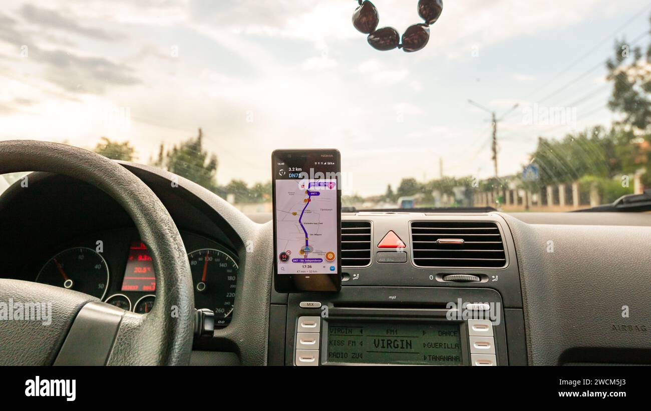 Smartphone showing Waze maps to show the way thru the city. Driver ...