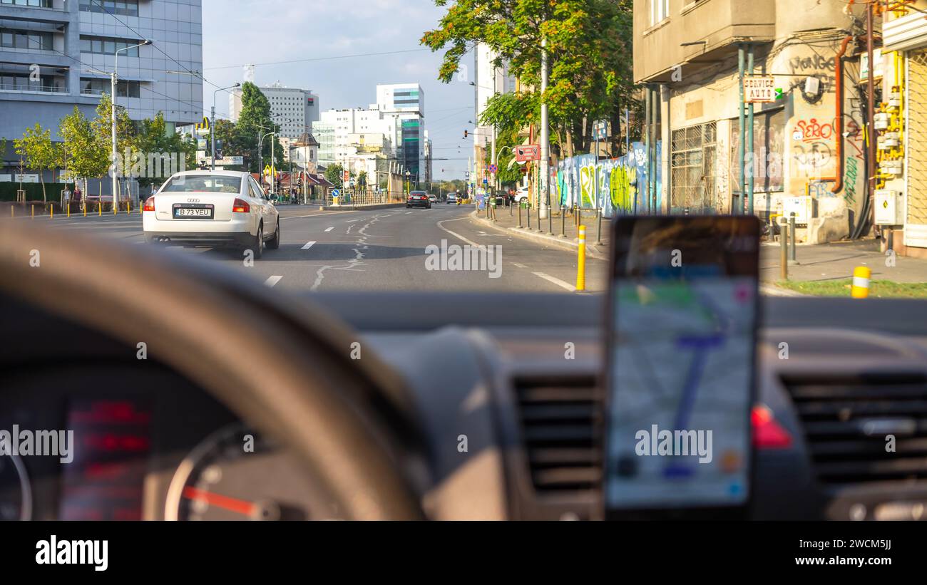 Smartphone showing Waze maps to show the way thru the city. Driver ...