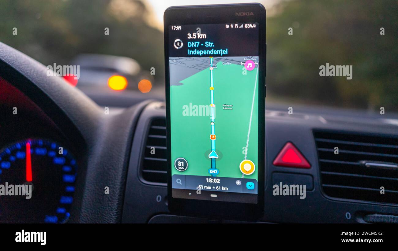 Smartphone showing Waze maps to show the way thru the city. Driver ...