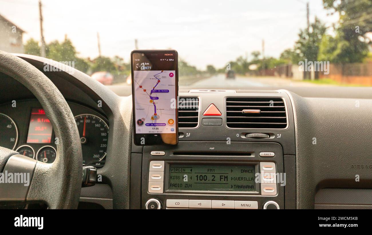 Smartphone showing Waze maps to show the way thru the city. Driver ...