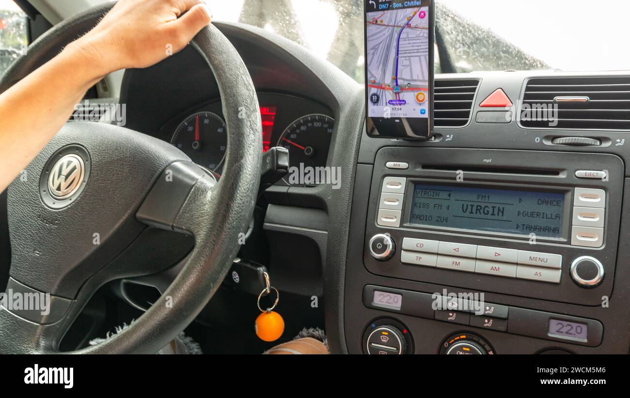 Smartphone showing Waze maps to show the way thru the city. Driver ...