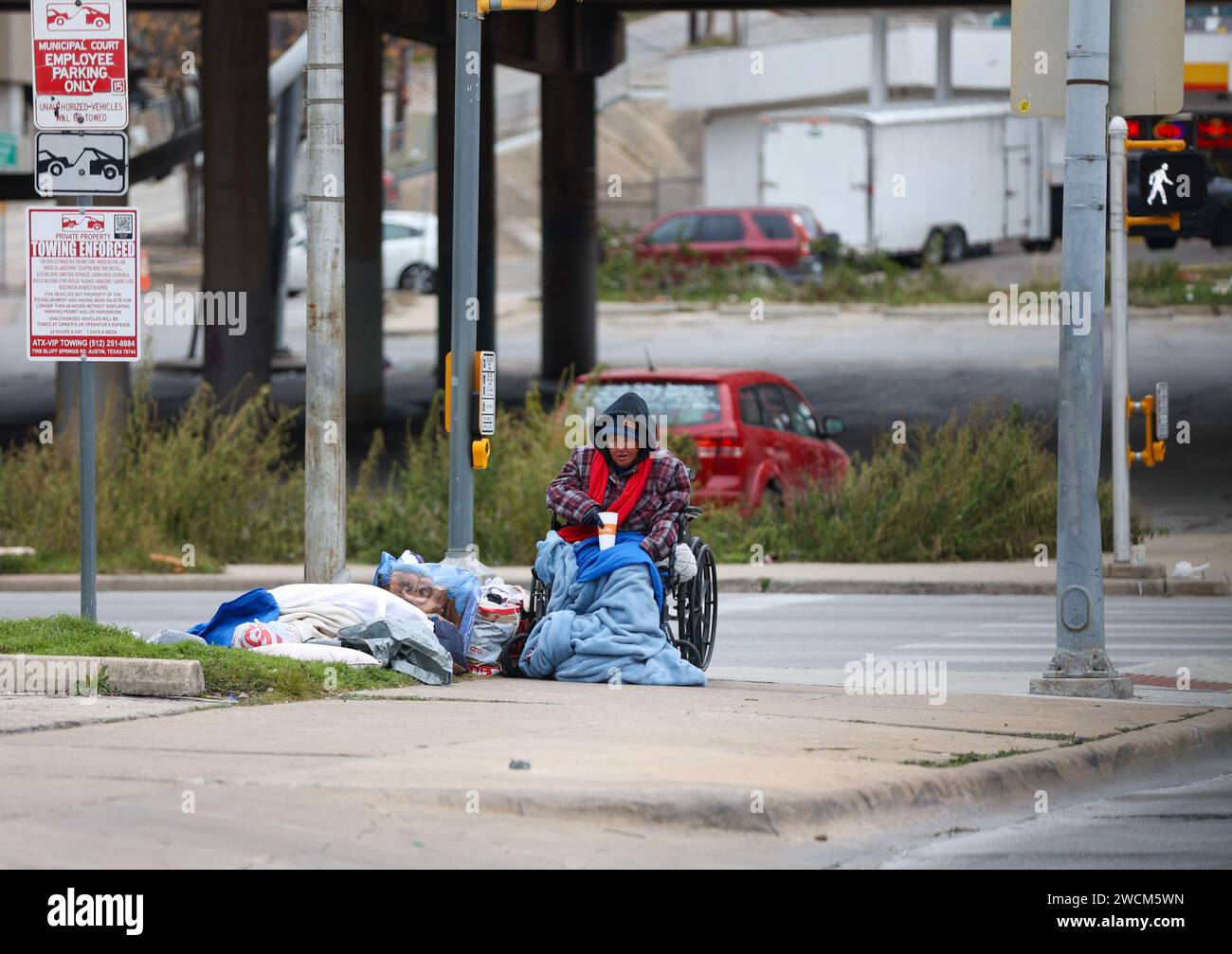 January 15, 2024: A woman in a wheelchair sits with her belongings near ...