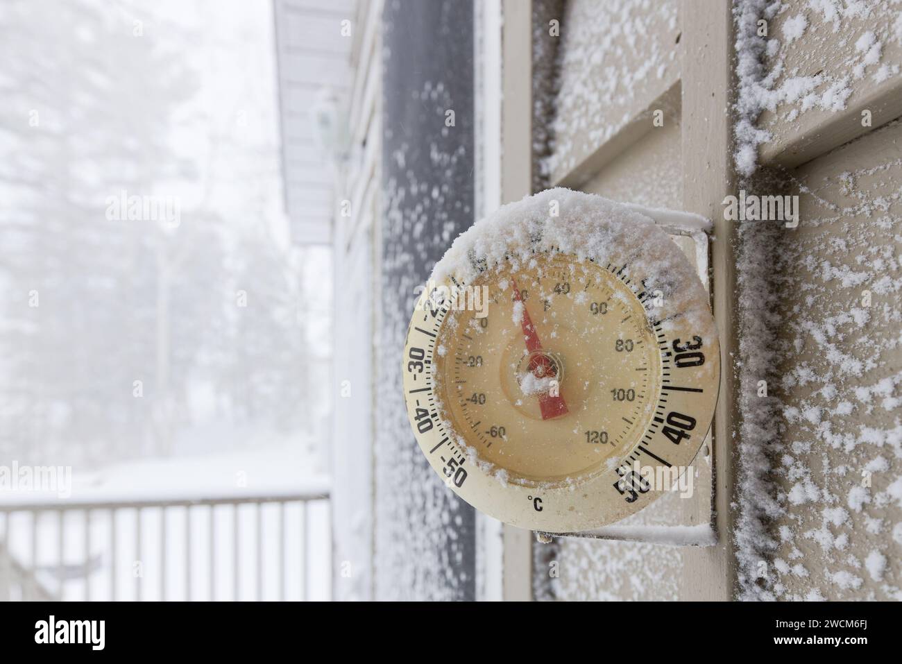 Snow Capped Thermometer Mounted on Wooden Siding of House Showing ...