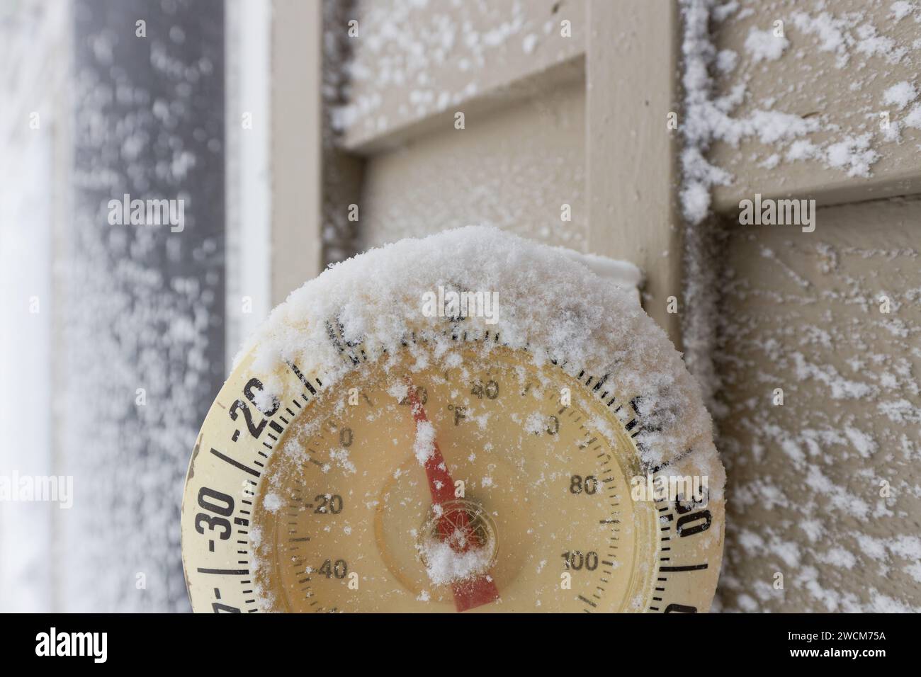 Snow Capped Thermometer Mounted on Wooden Siding of House Showing ...