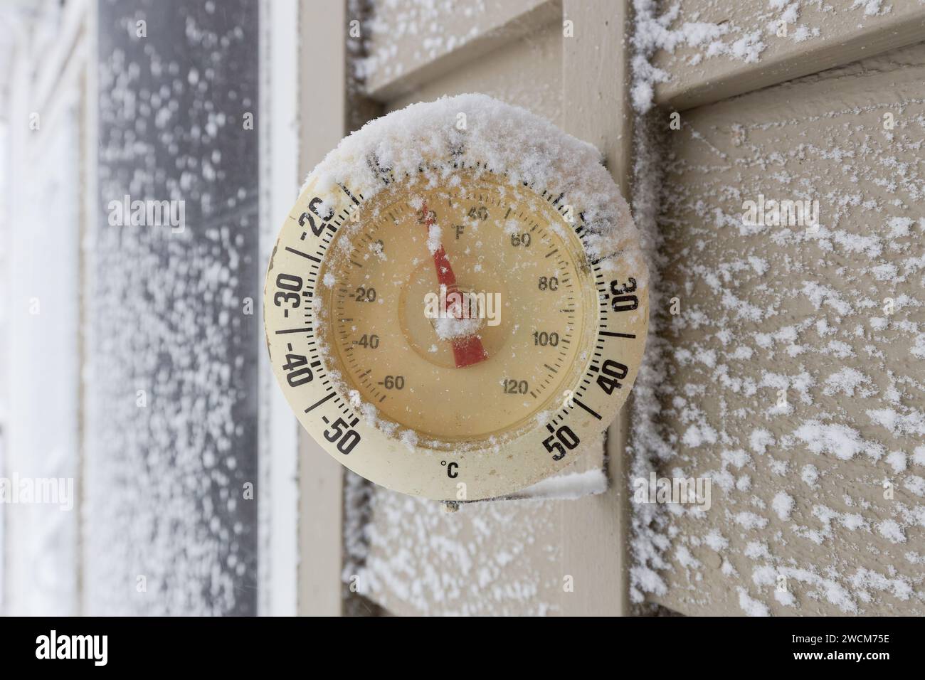 Snow Capped Thermometer Mounted on Wooden Siding of House Showing ...