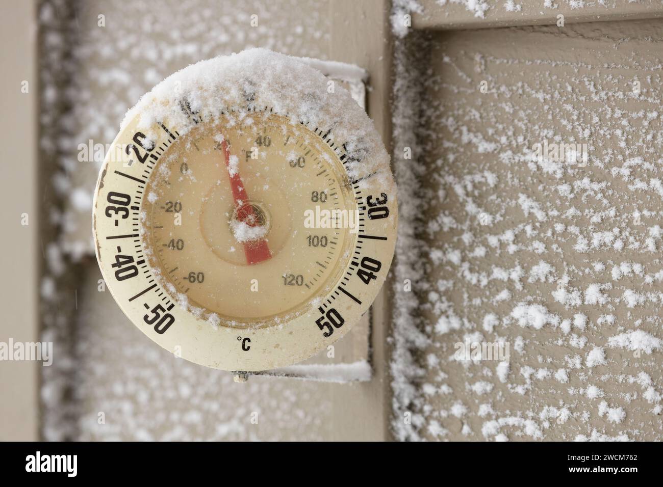 Snow Capped Thermometer Mounted on Wooden Siding of House Showing ...