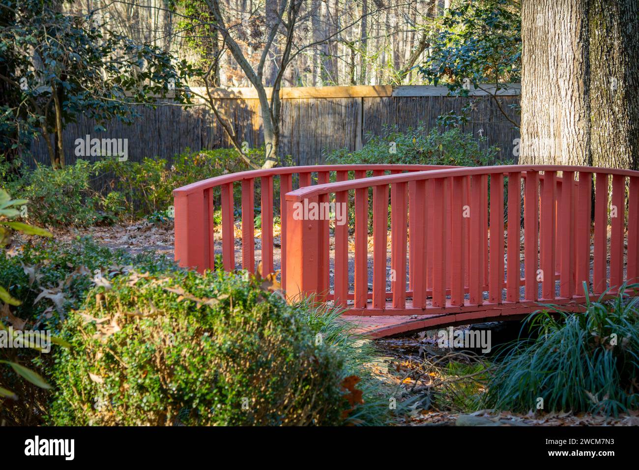 Small Red Bridge in Calming Sunlit Garden Stock Photo - Alamy
