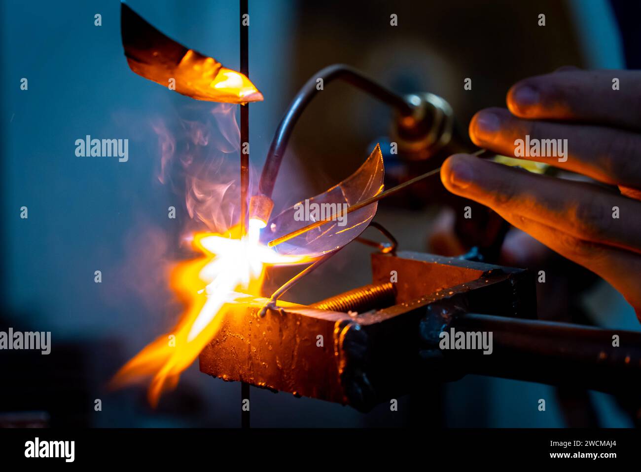 A craftsman welding a metal rose Stock Photo - Alamy