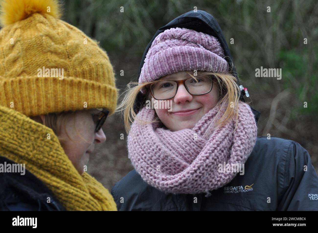 Happy teenage girl with mum wrapped up warmly in Winter Stock Photo - Alamy