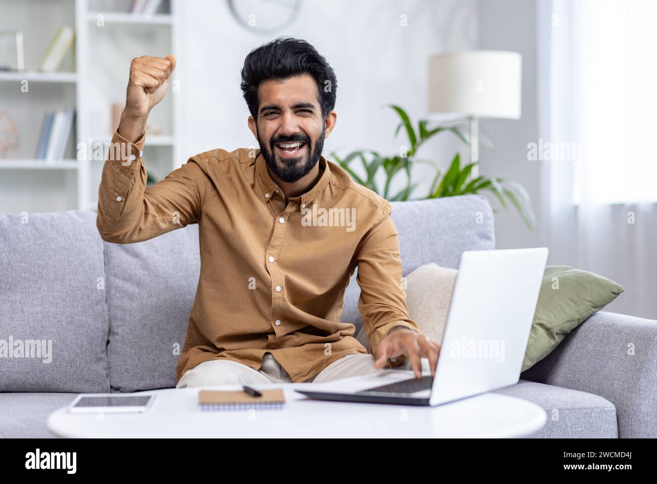 Portrait of an Indian young man rejoicing in success and achievement ...