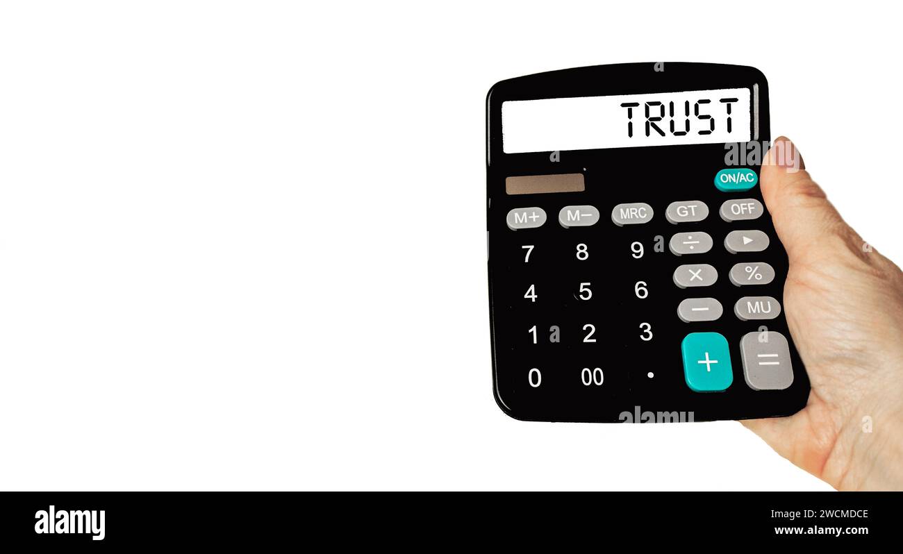 A calculator with the word TRUST on the display is held by a female ...