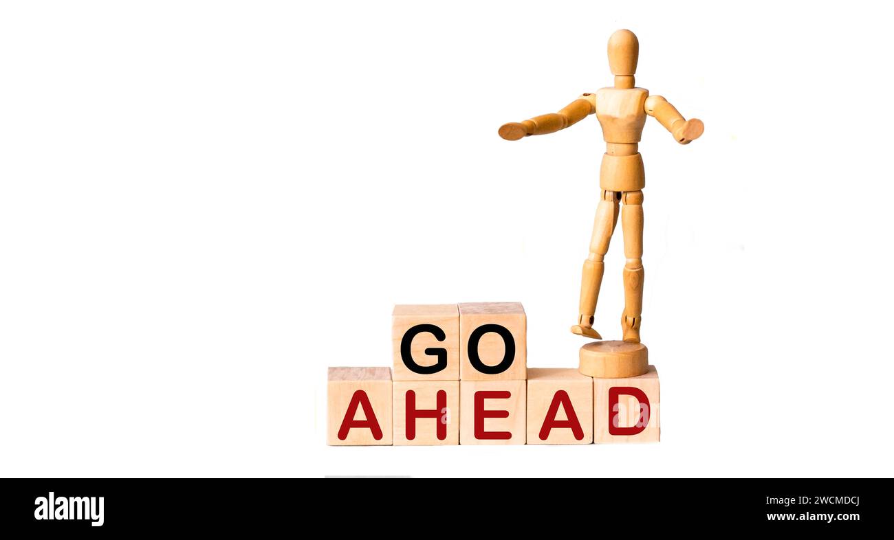 Go ahead text image on wooden blocks and a white background, next to a ...