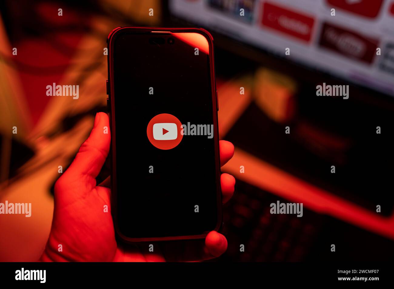 Man holding iPhone 14 Pro Max smartphone with Youtube app in front of ...