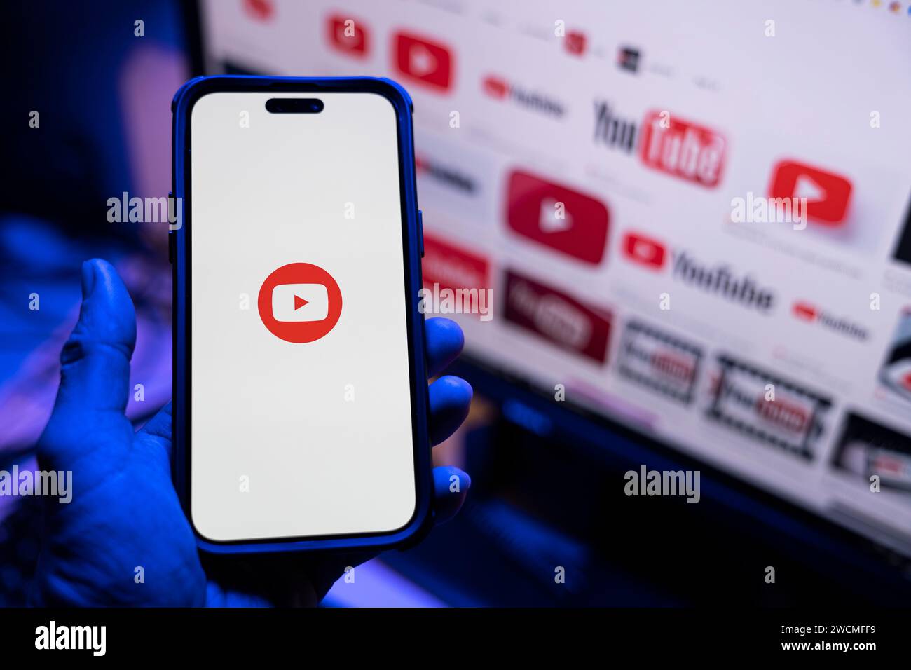 Man holding iPhone 14 Pro Max smartphone with Youtube app in front of ...