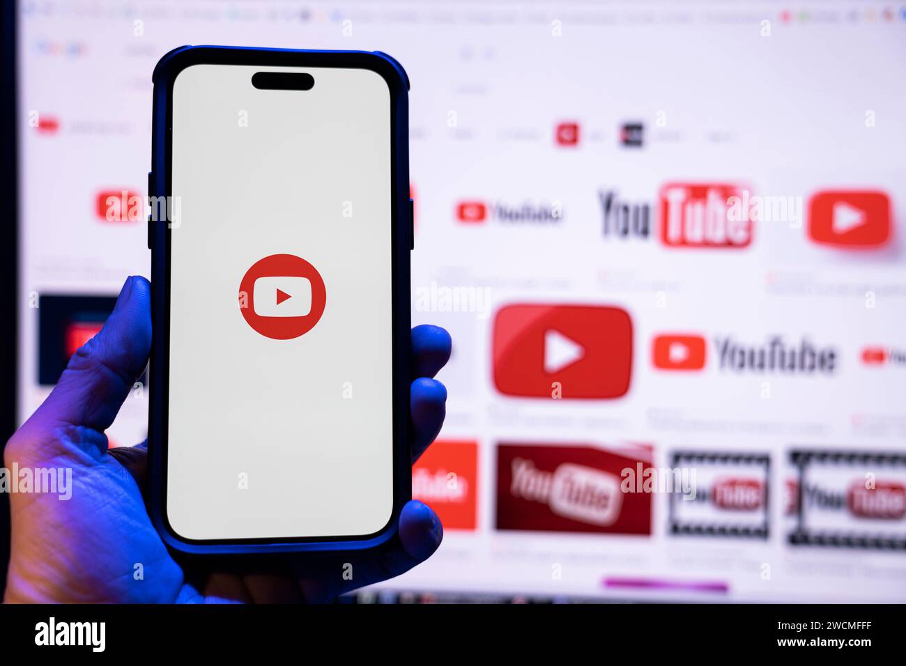 Man holding iPhone 14 Pro Max smartphone with Youtube app in front of ...