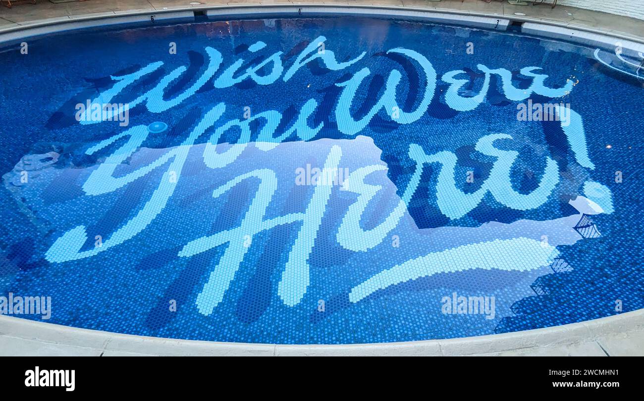 Vacation pool with Wish you were here message Stock Photo - Alamy