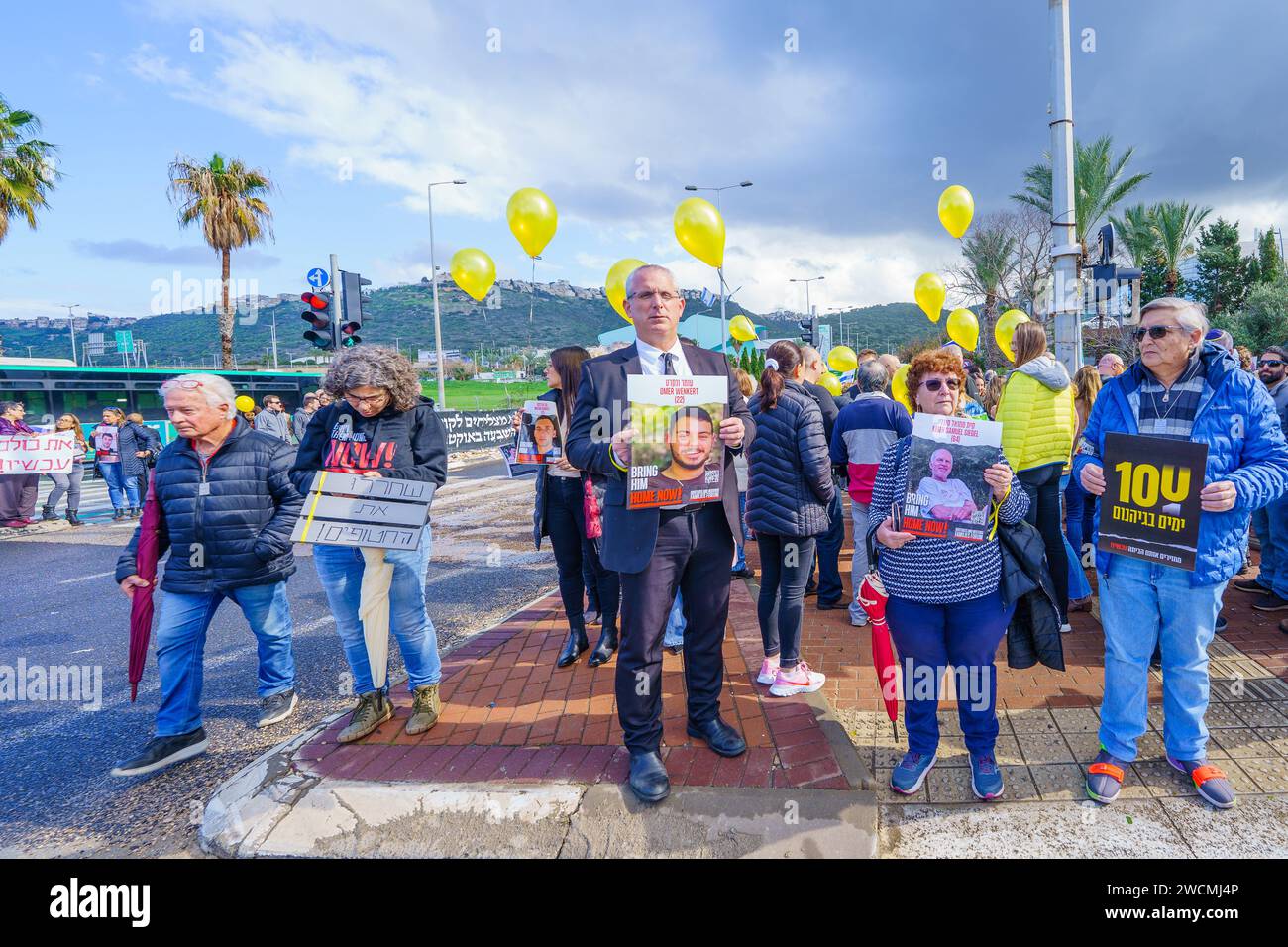 Haifa, Israel - January 14, 2024: People with various signs and flags ...