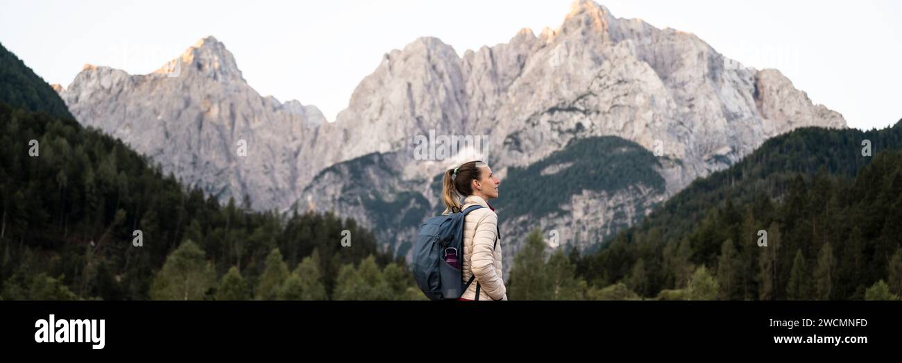 Profile view of a young female hiker looking at a beautiful view of ...