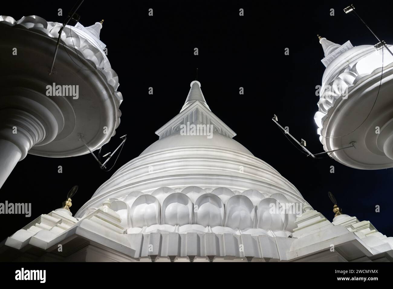 White domes of the Mahamevnawa Amawatura Monastery are under night sky ...