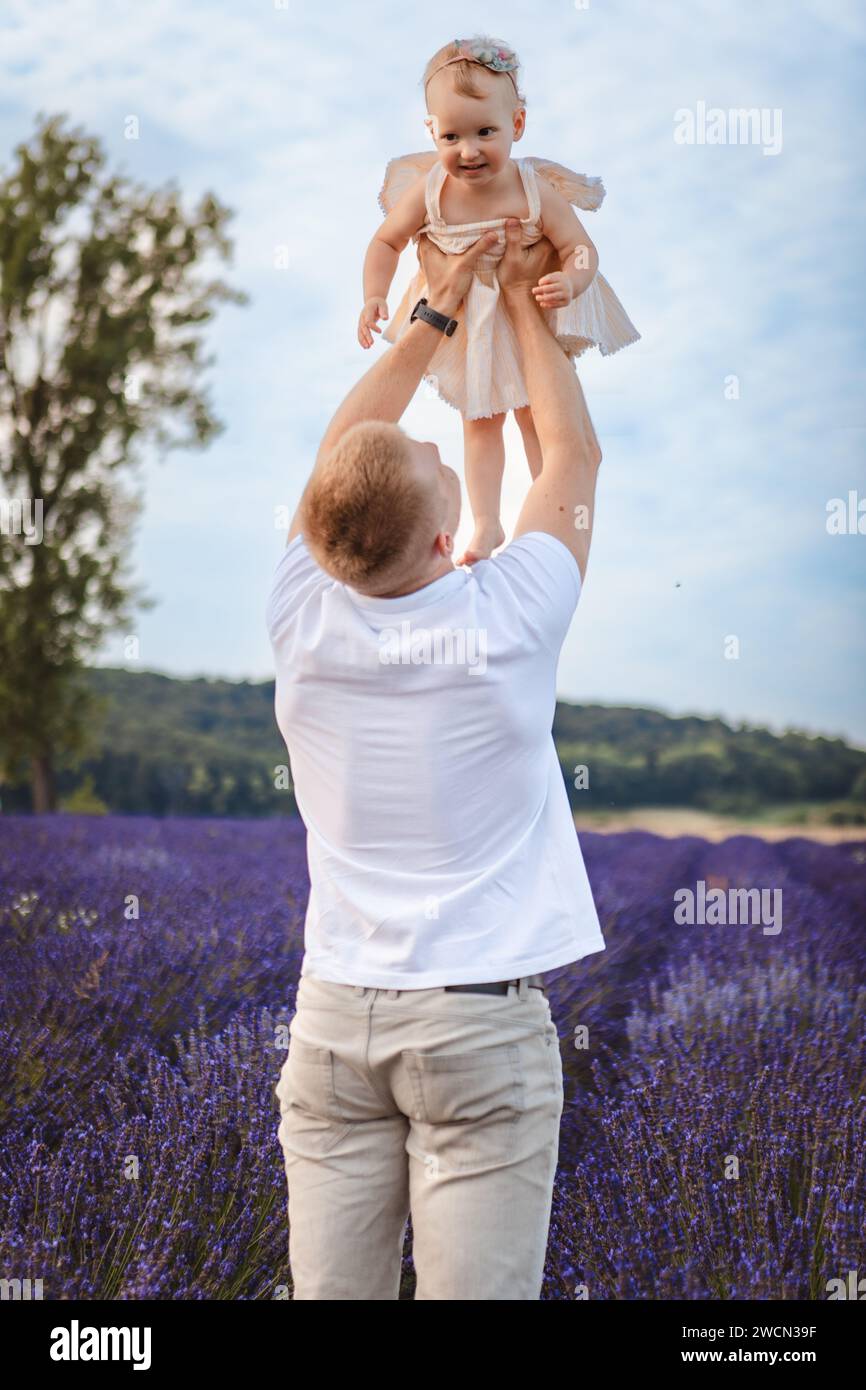 father lifts his daughter Stock Photo - Alamy