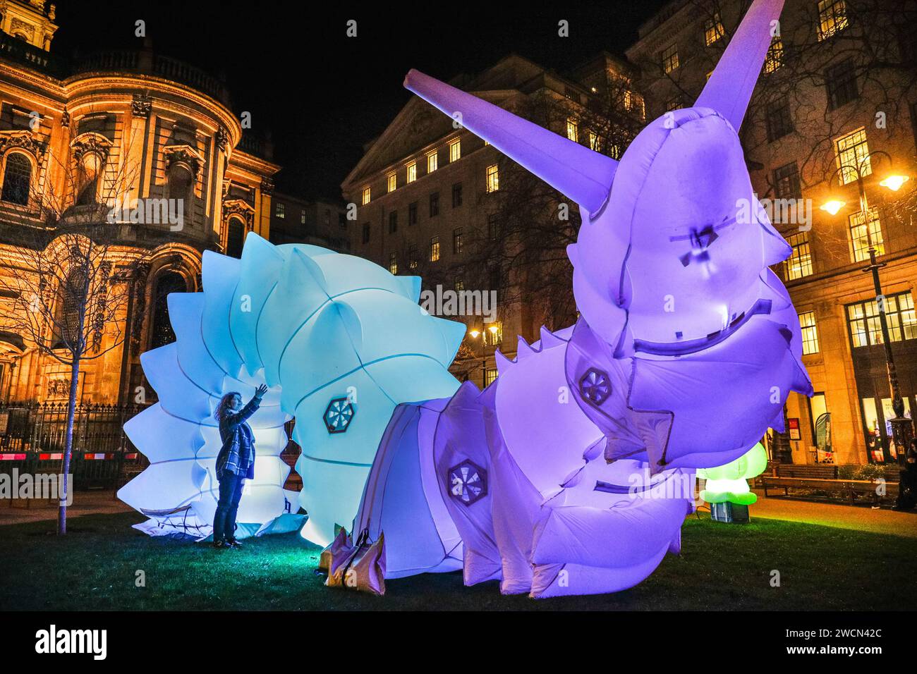 London, UK. 16th Jan, 2024. Staff pose with Luma, the snail creature ...