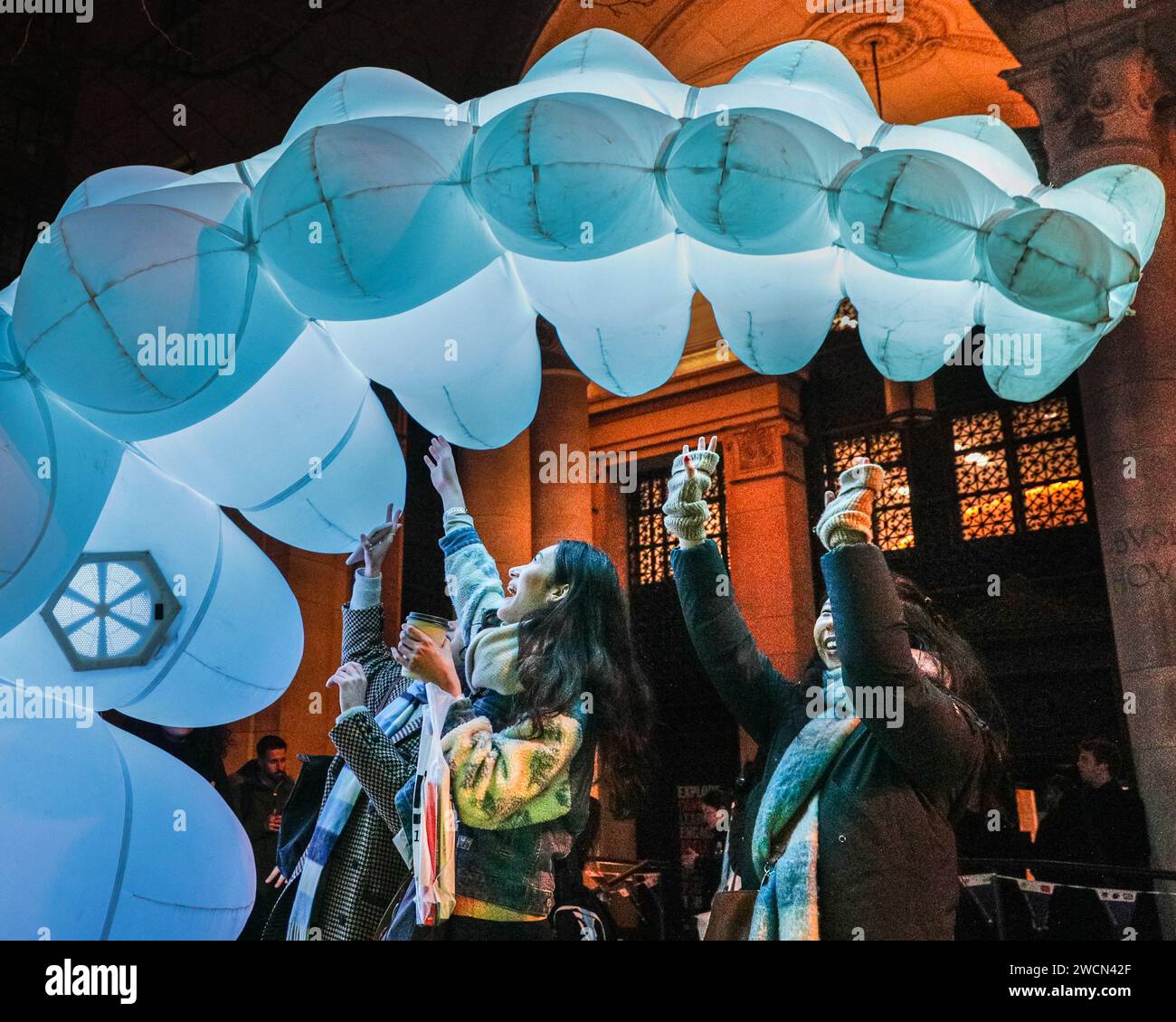 London, UK. 16th Jan, 2024. Visitors have fun with an installation ...