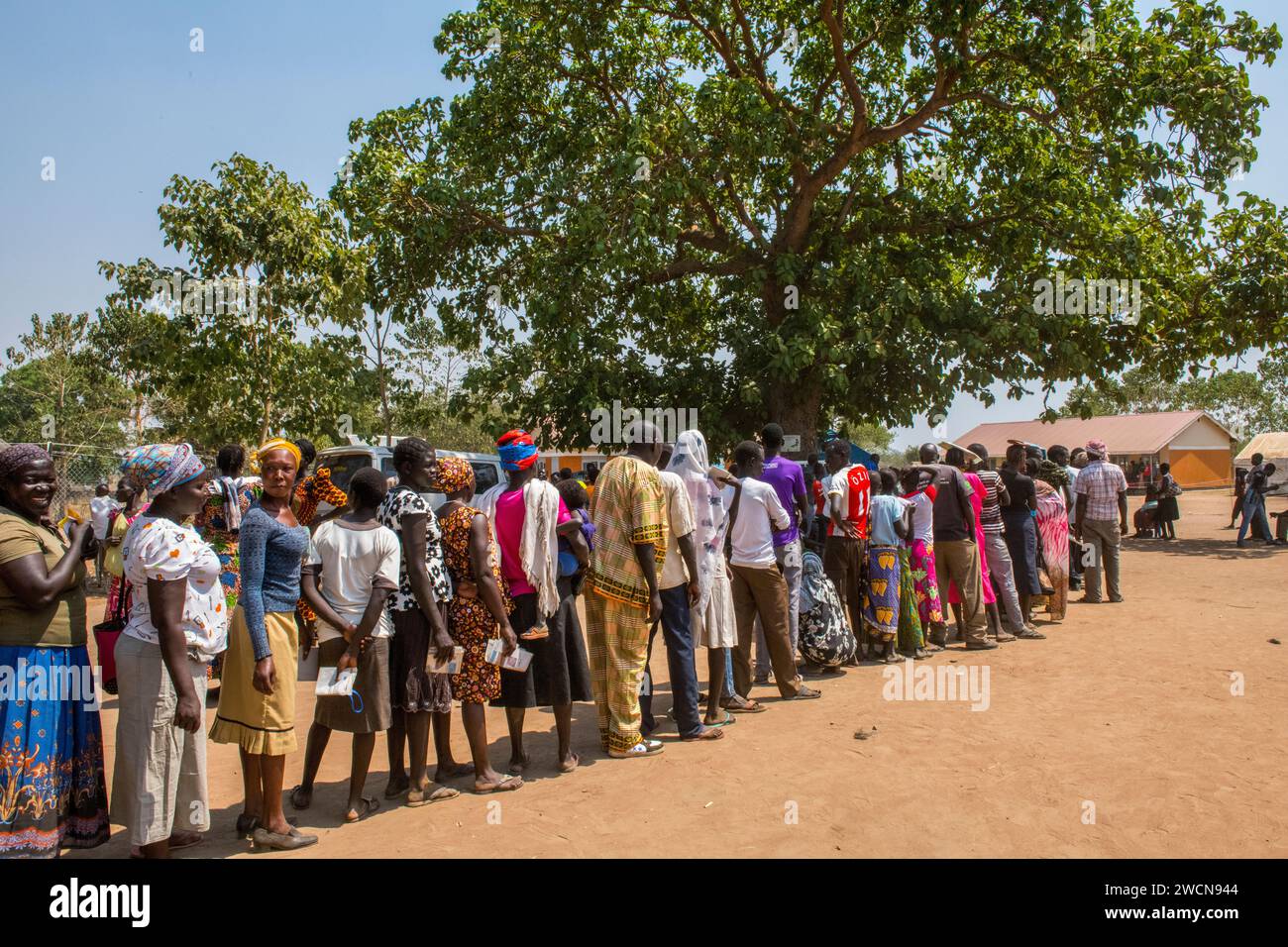 Uganda, Adjumani. South Sudan refugees in refugee camps line up for ...