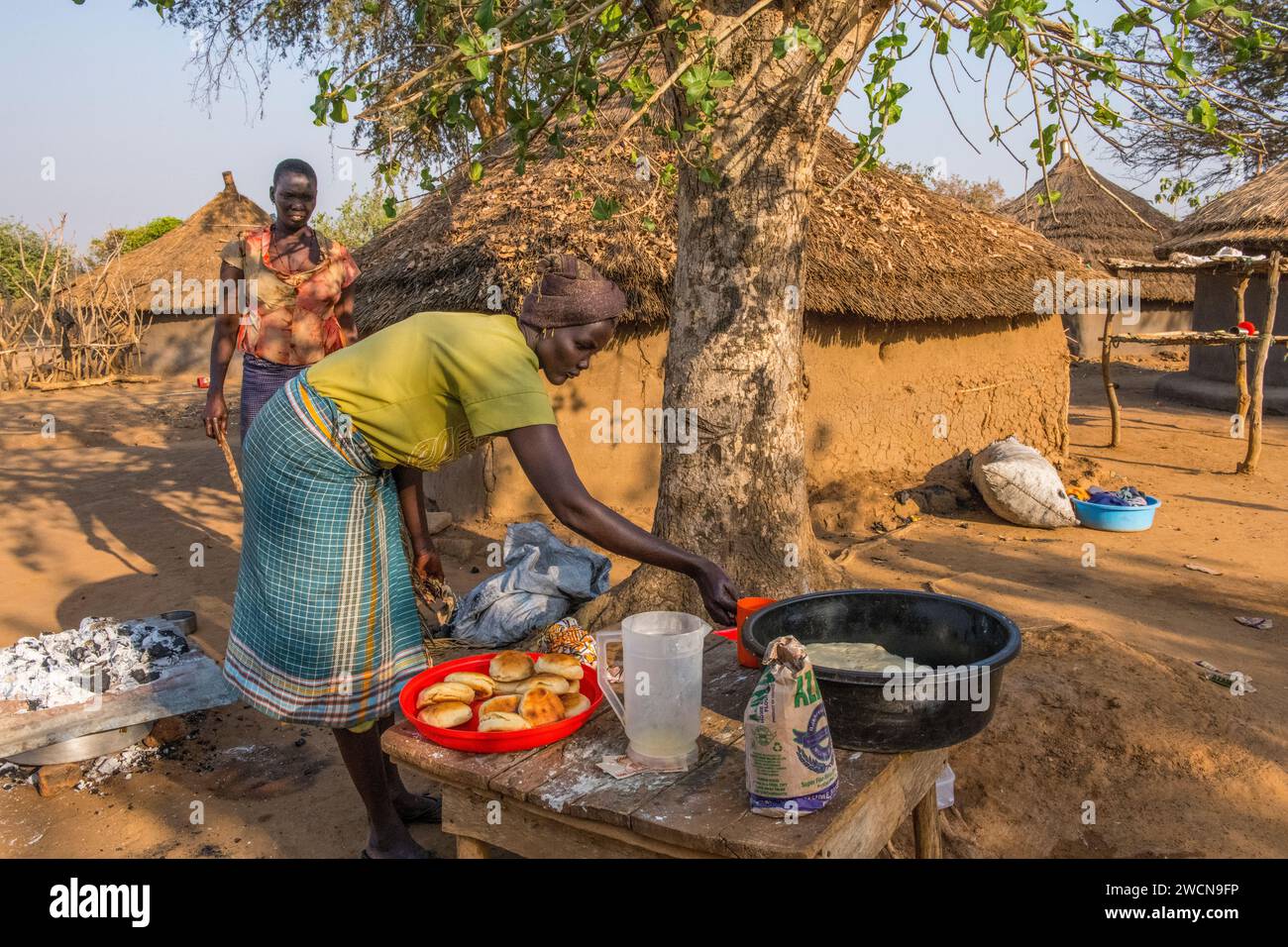 Uganda, Adjumani. Women from South Sudan make bread to sell in the ...
