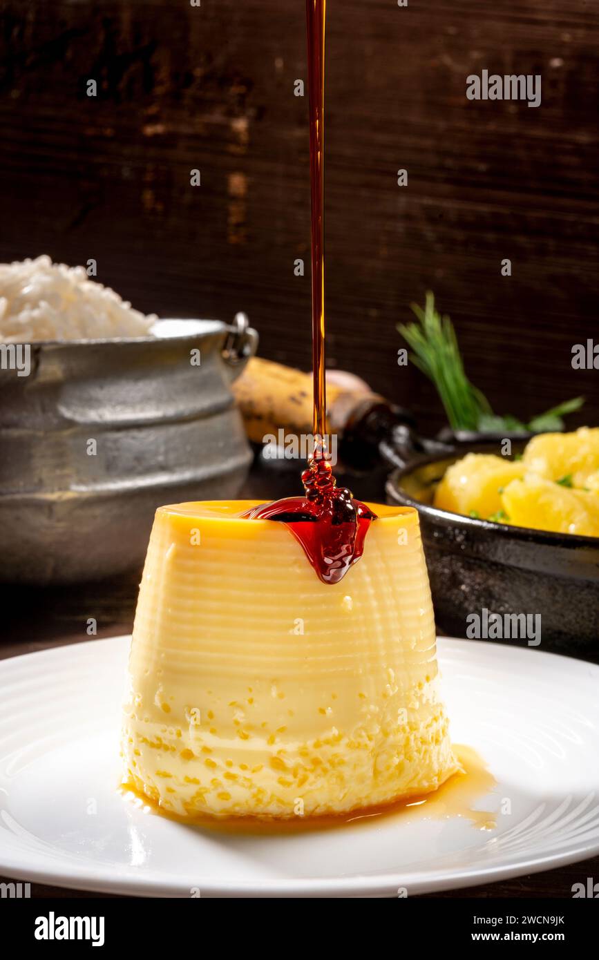 close up of a sweet syrup pouring over caramel custard pudding on a ...
