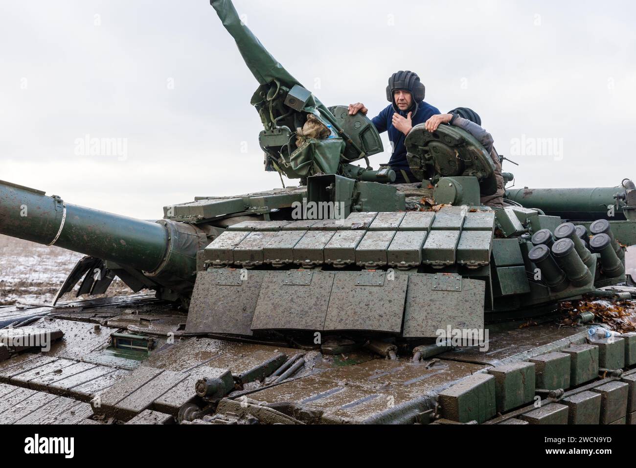 A tank crewman of the Ukrainian armed forces is seen on the tank turret ...