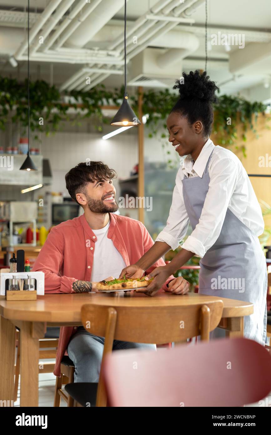 African american waitress taking order from customer in a cafe Stock ...