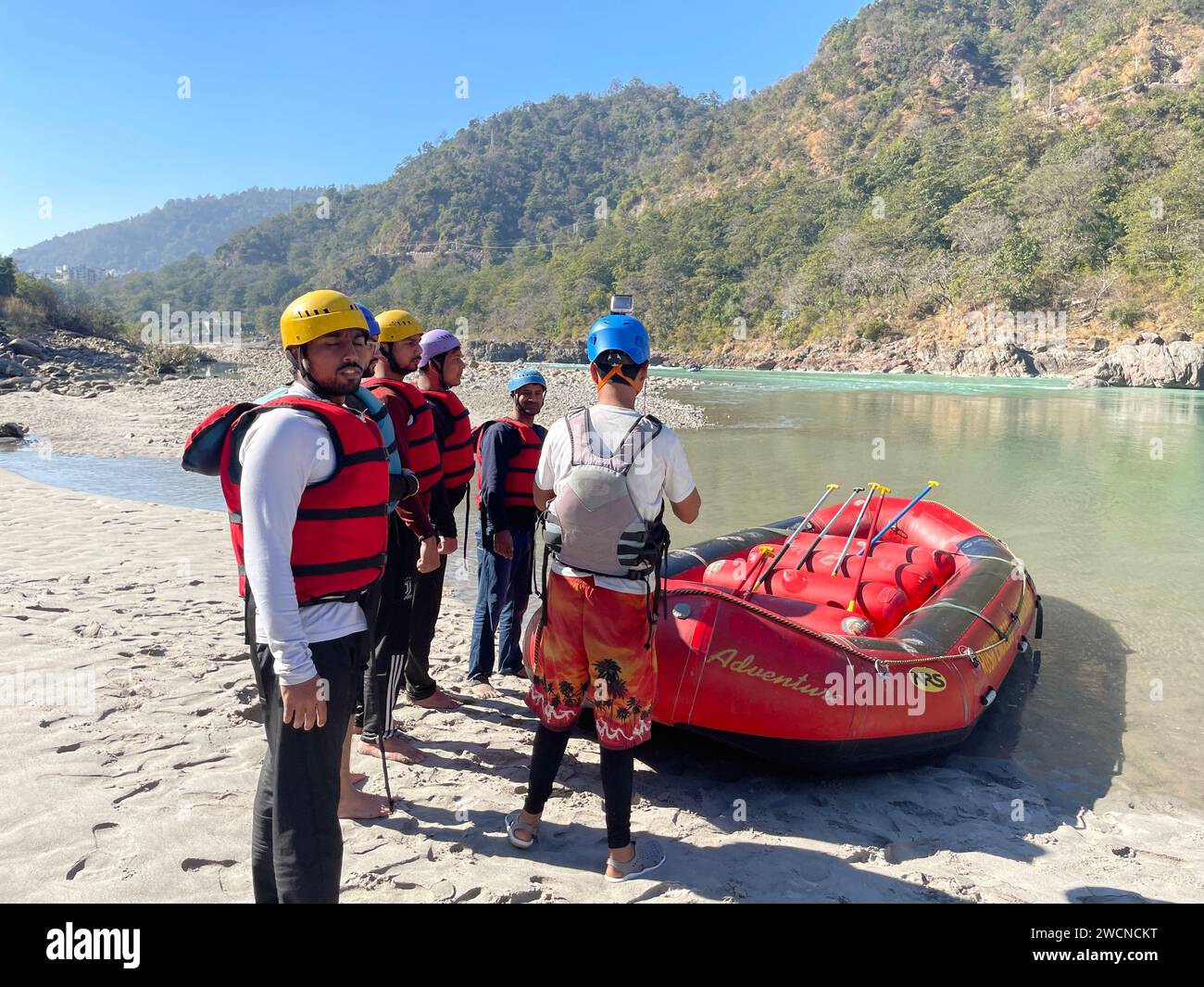 Group of rafters posing with their raft on the riverbank Stock Photo ...