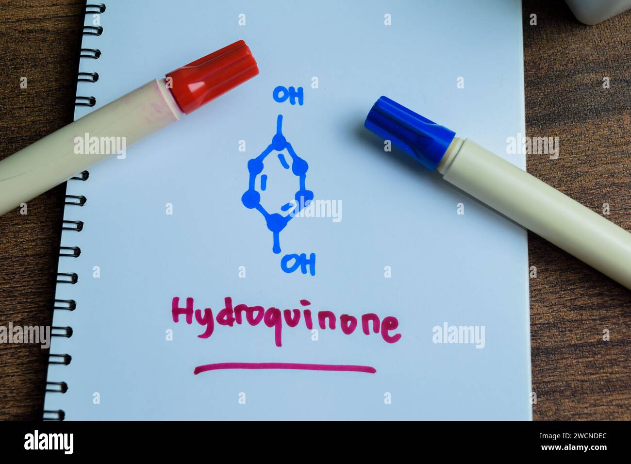 Concept of Hydroquinone molecule write on book isolated on Wooden Table ...