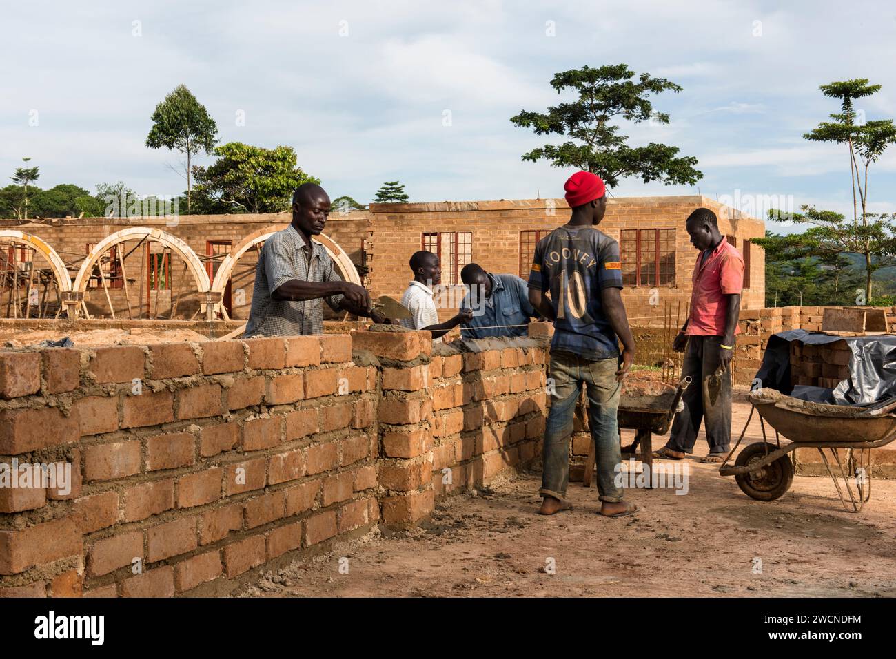 Uganda, Mukono District. A new school being built by handmade bricks ...